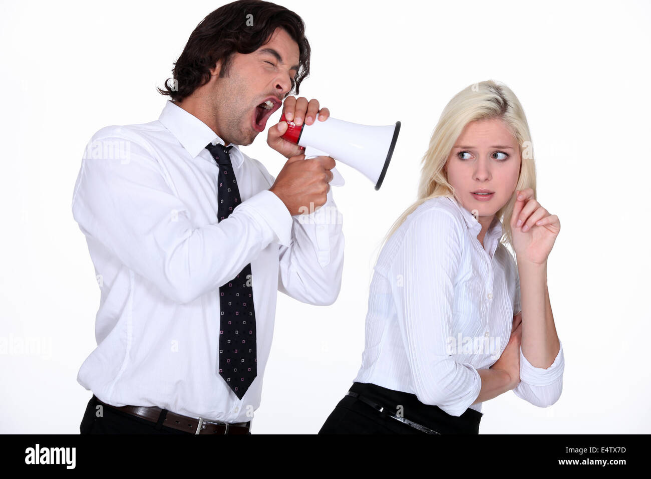 Man shouting at colleague through megaphone Stock Photo - Alamy