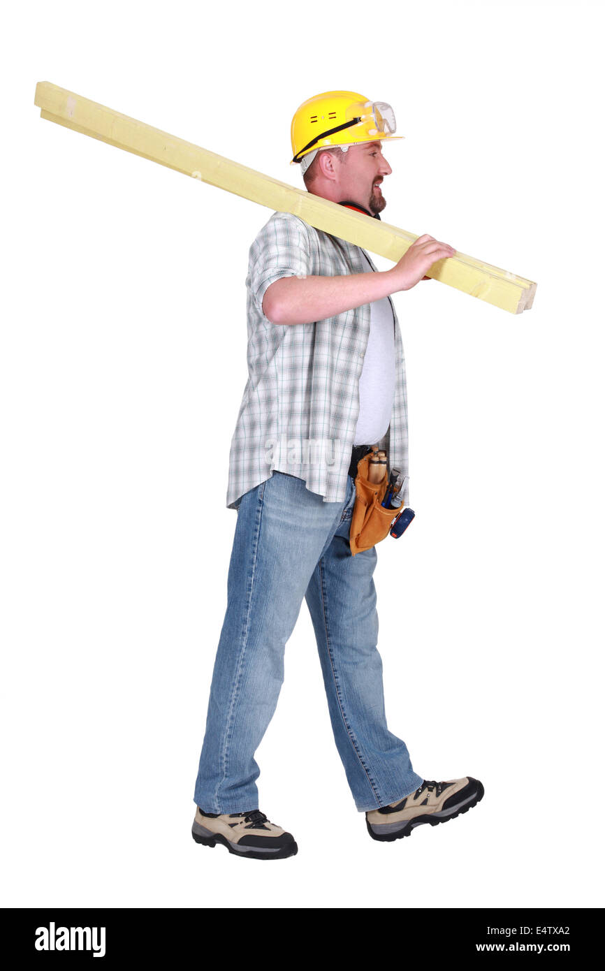 Man carrying plank of wood Stock Photo - Alamy
