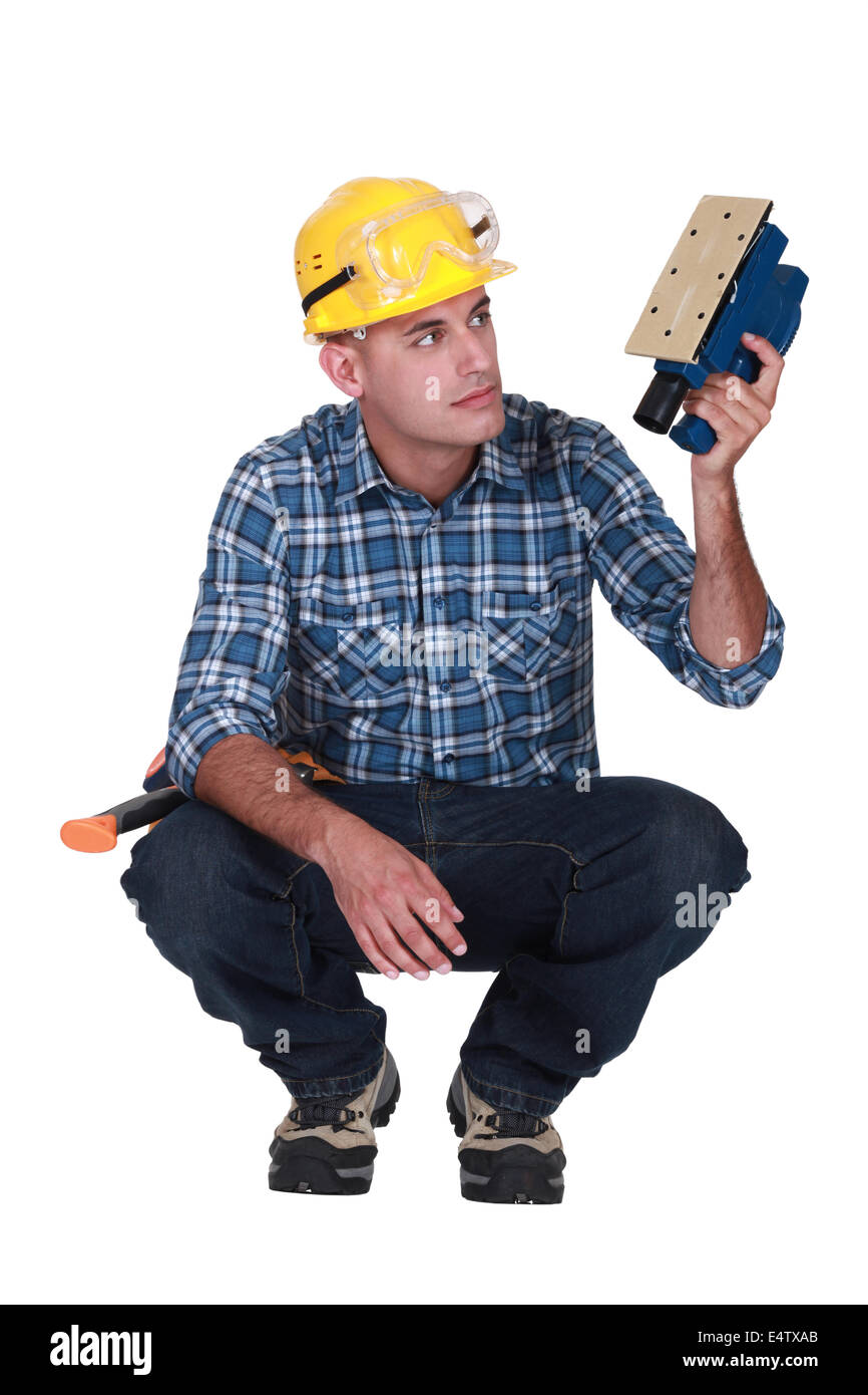 Worker with an electric sander Stock Photo - Alamy