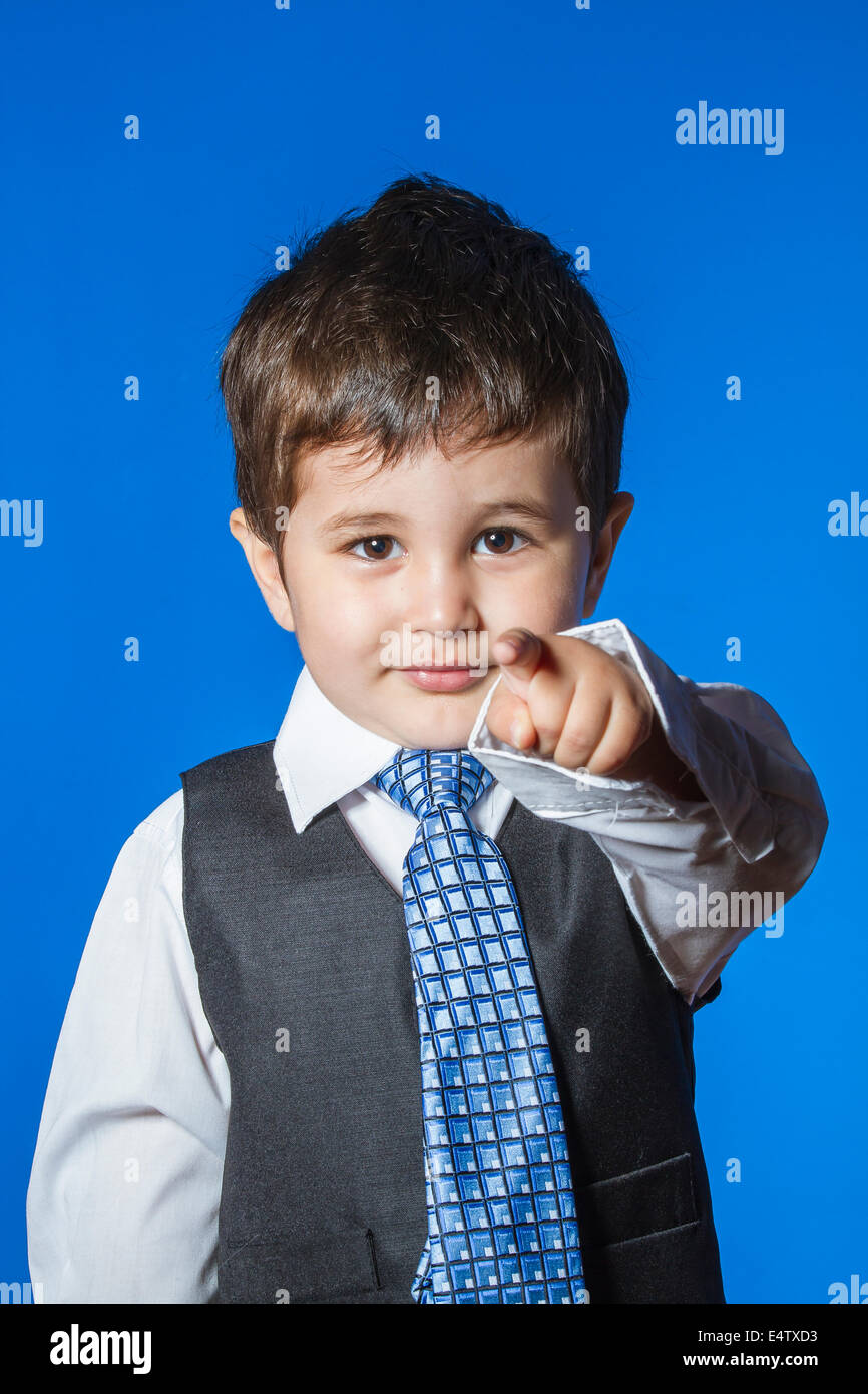 Leader, cute little boy portrait over blue chroma background Stock ...