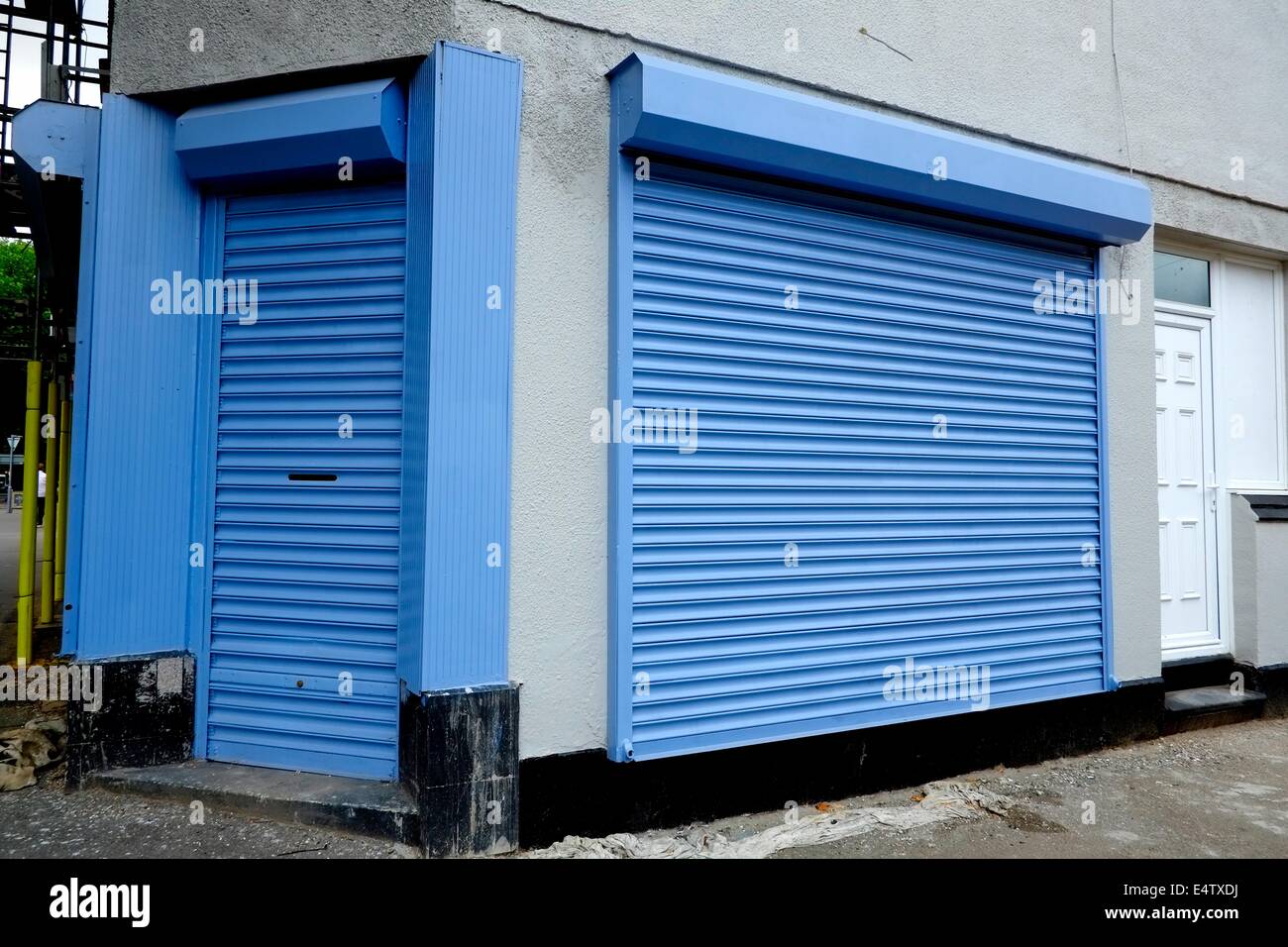 A closed corner shop with freshly painted shutters England uk Stock ...