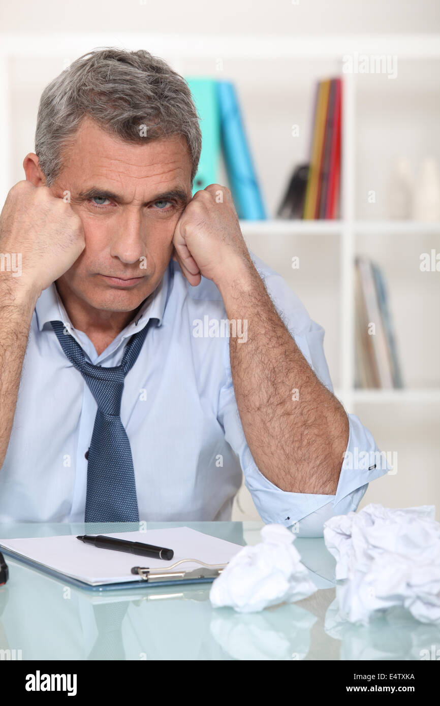 uninspired writer amid paper balls Stock Photo - Alamy