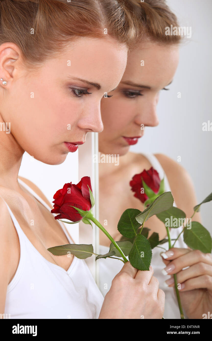 Beautiful woman holding a rose Stock Photo - Alamy