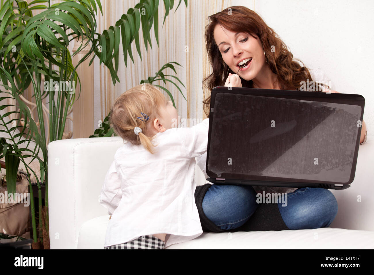 Mother and baby with laptop Stock Photo - Alamy