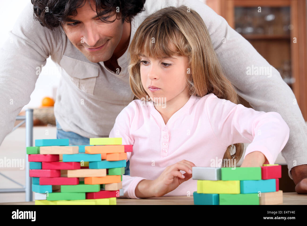 Little girl playing with building blocks Stock Photo - Alamy