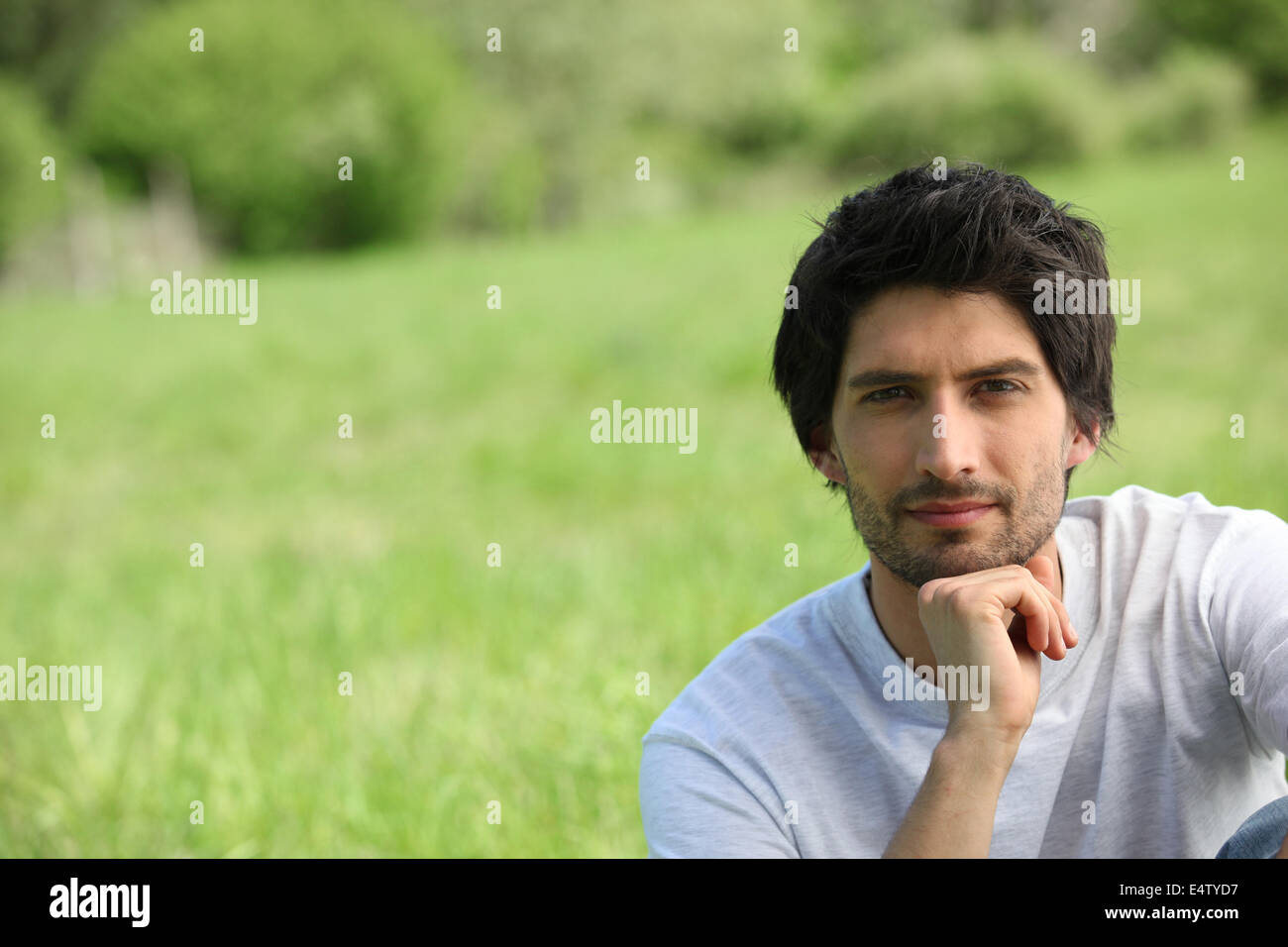 Man sat in field Stock Photo - Alamy