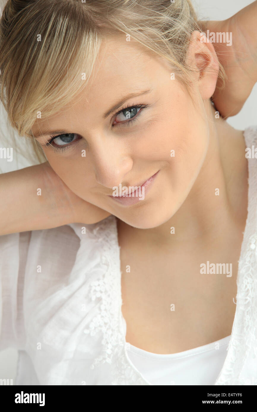 Woman with hands on neck Stock Photo - Alamy