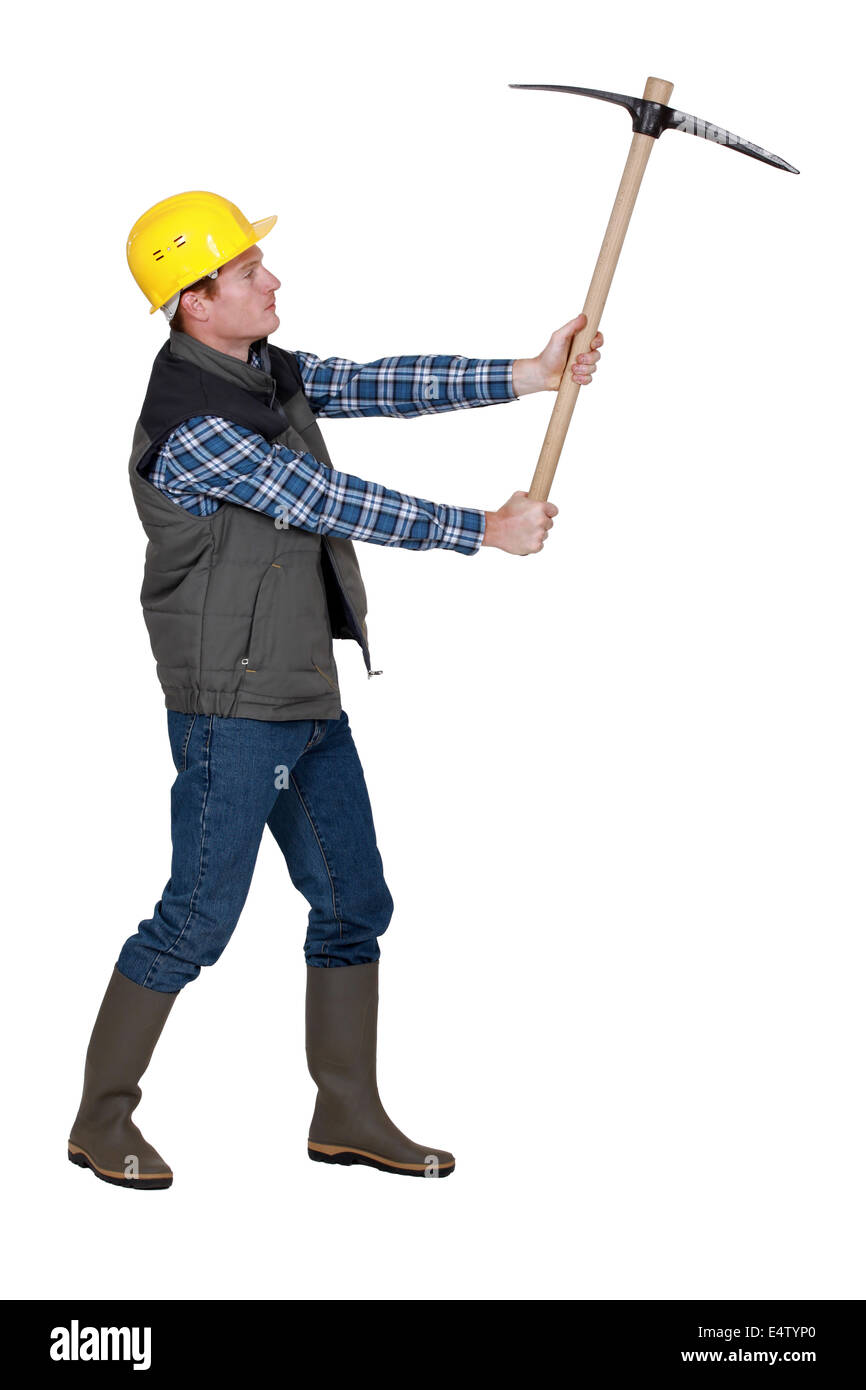 Man wielding pick-axe Stock Photo - Alamy