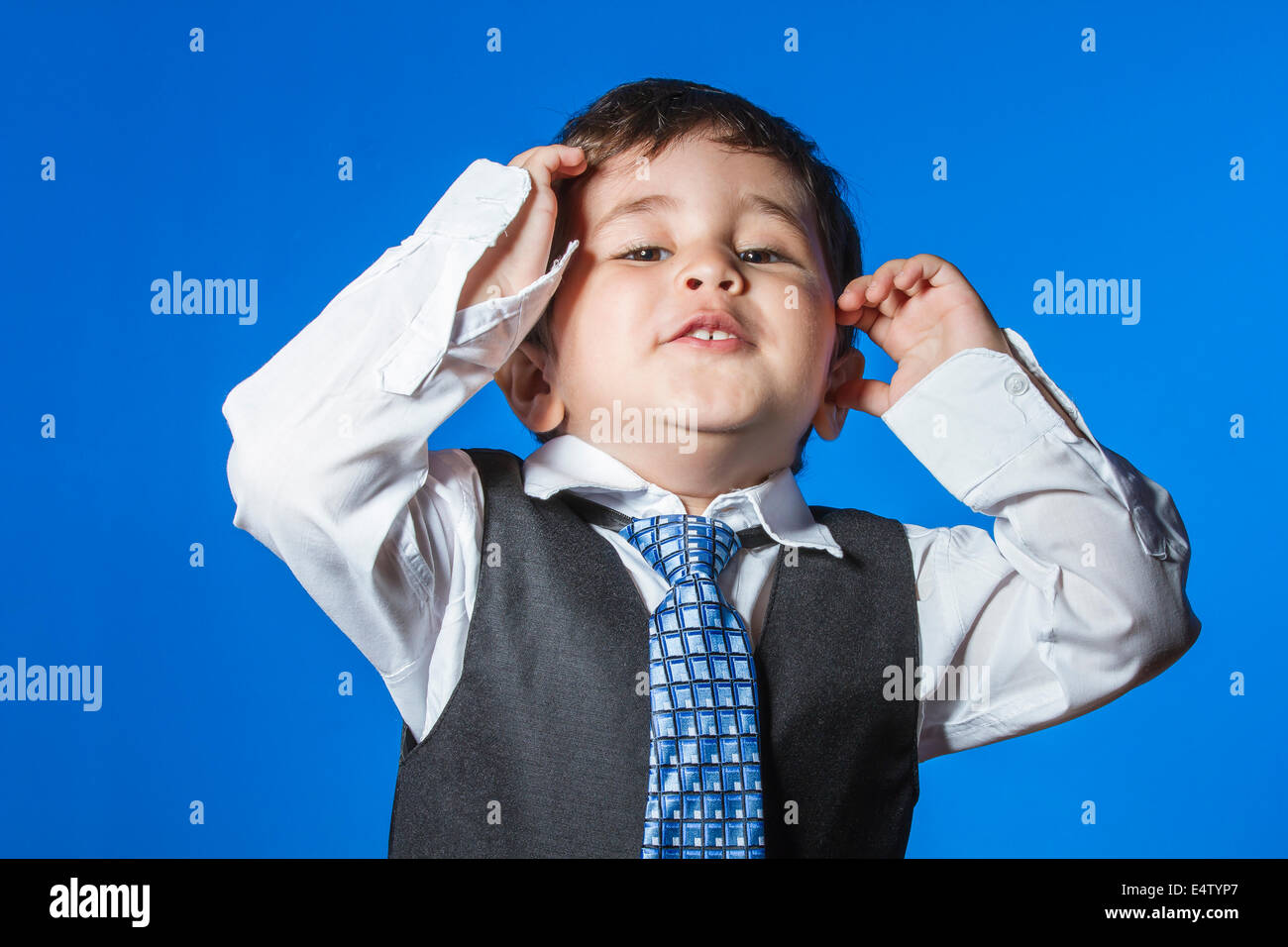 Leader, cute little boy portrait over blue chroma background Stock ...