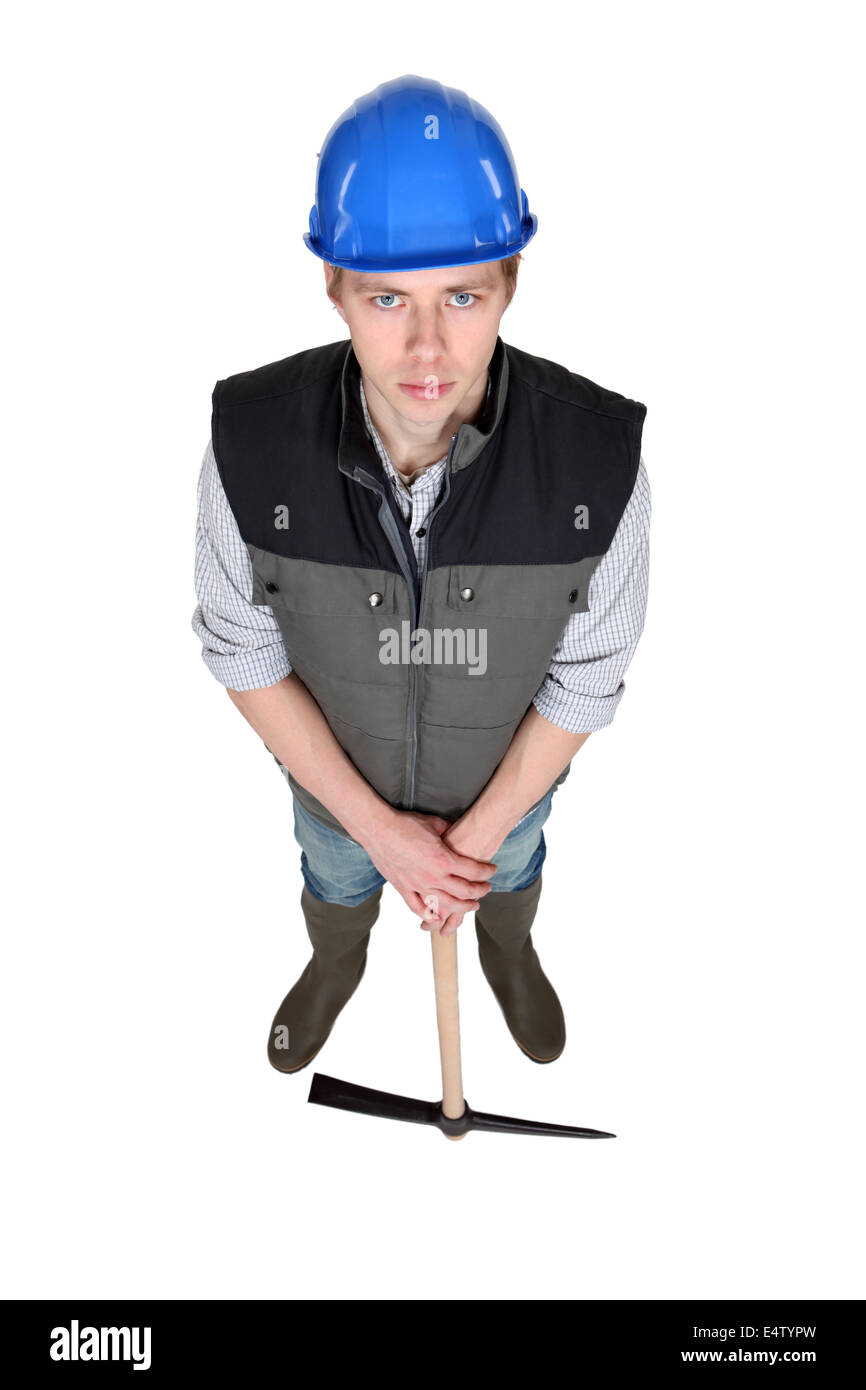 Young construction worker stood with pick-ax Stock Photo - Alamy