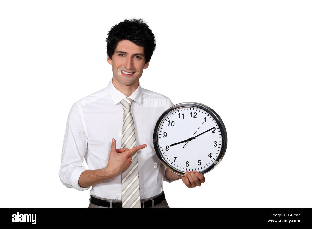 Happy businessman showing a clock Stock Photo - Alamy