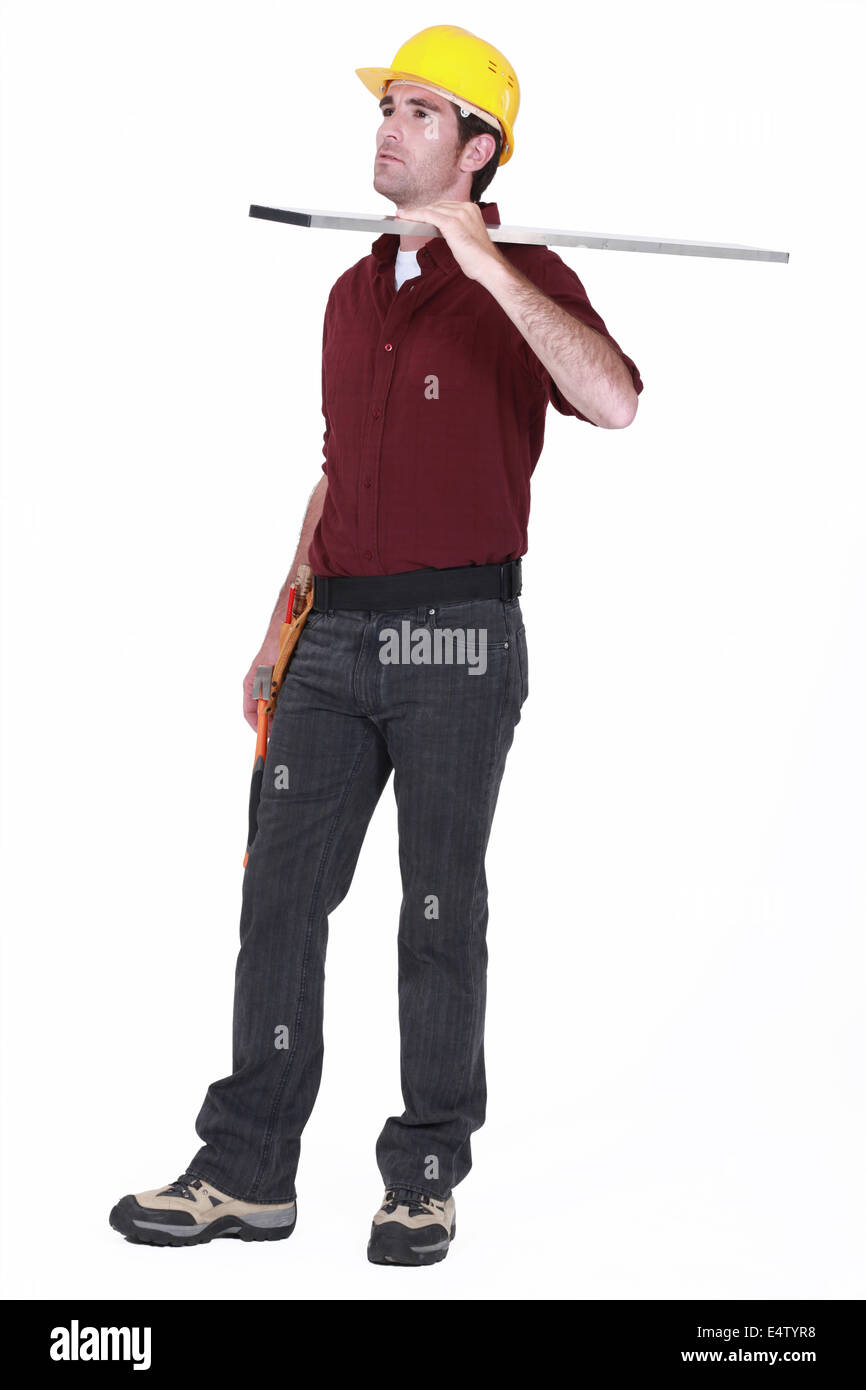craftsman carrying materials on his shoulder Stock Photo - Alamy