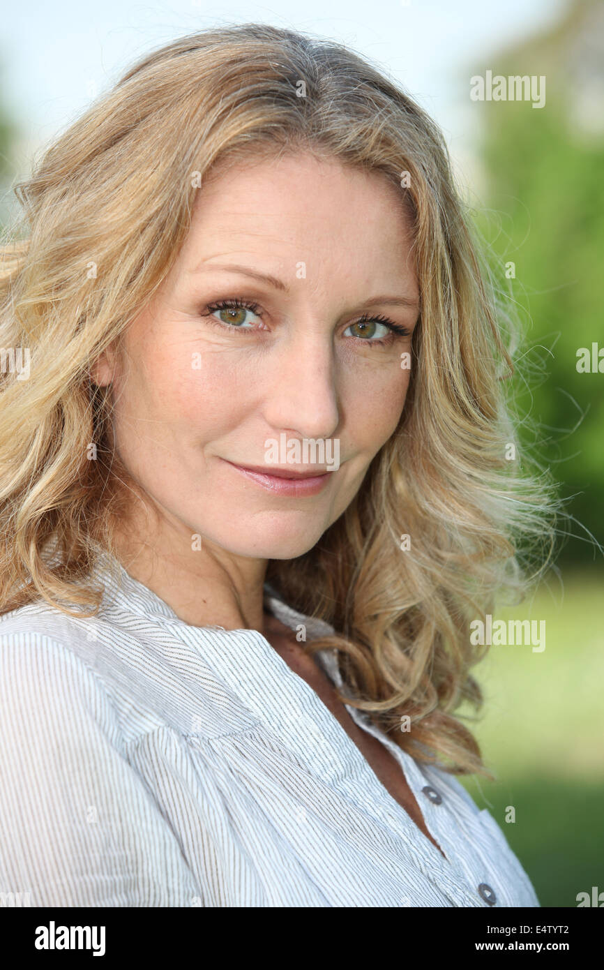 Woman outside smiling Stock Photo - Alamy