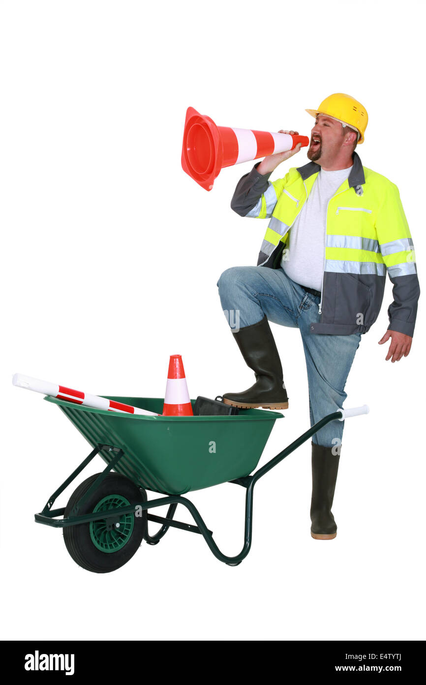 Builder shouting through cone Stock Photo - Alamy