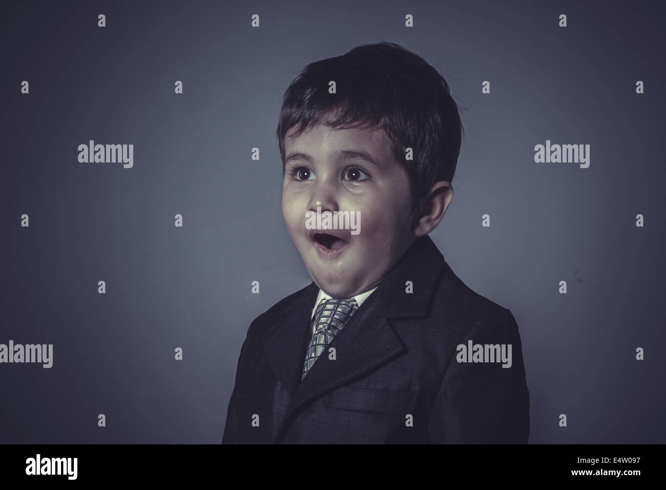 success little business boy over grey background Stock Photo - Alamy