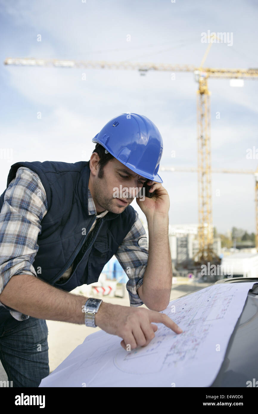 Foreman checking plan Stock Photo - Alamy