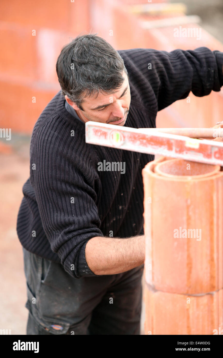 Bricklayer laying blocks hi-res stock photography and images - Alamy