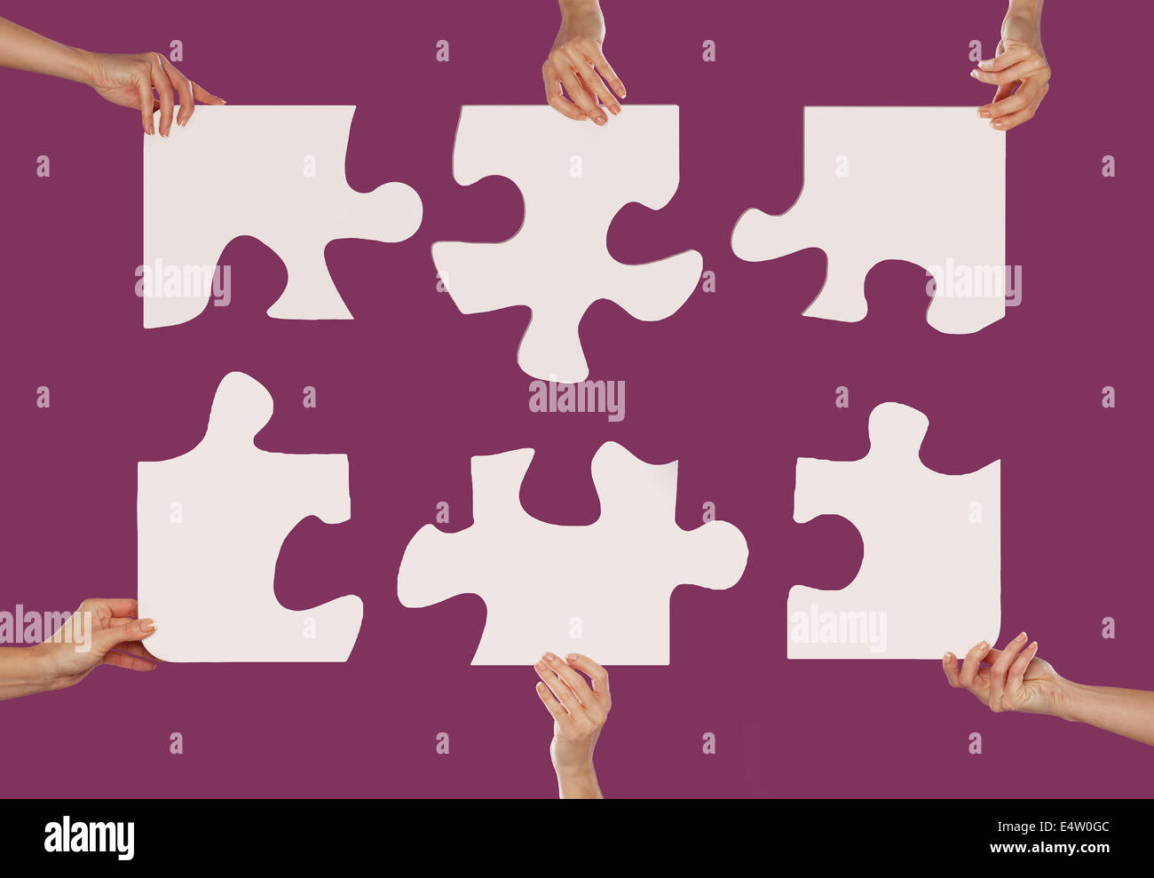 Hands and puzzle Stock Photo - Alamy