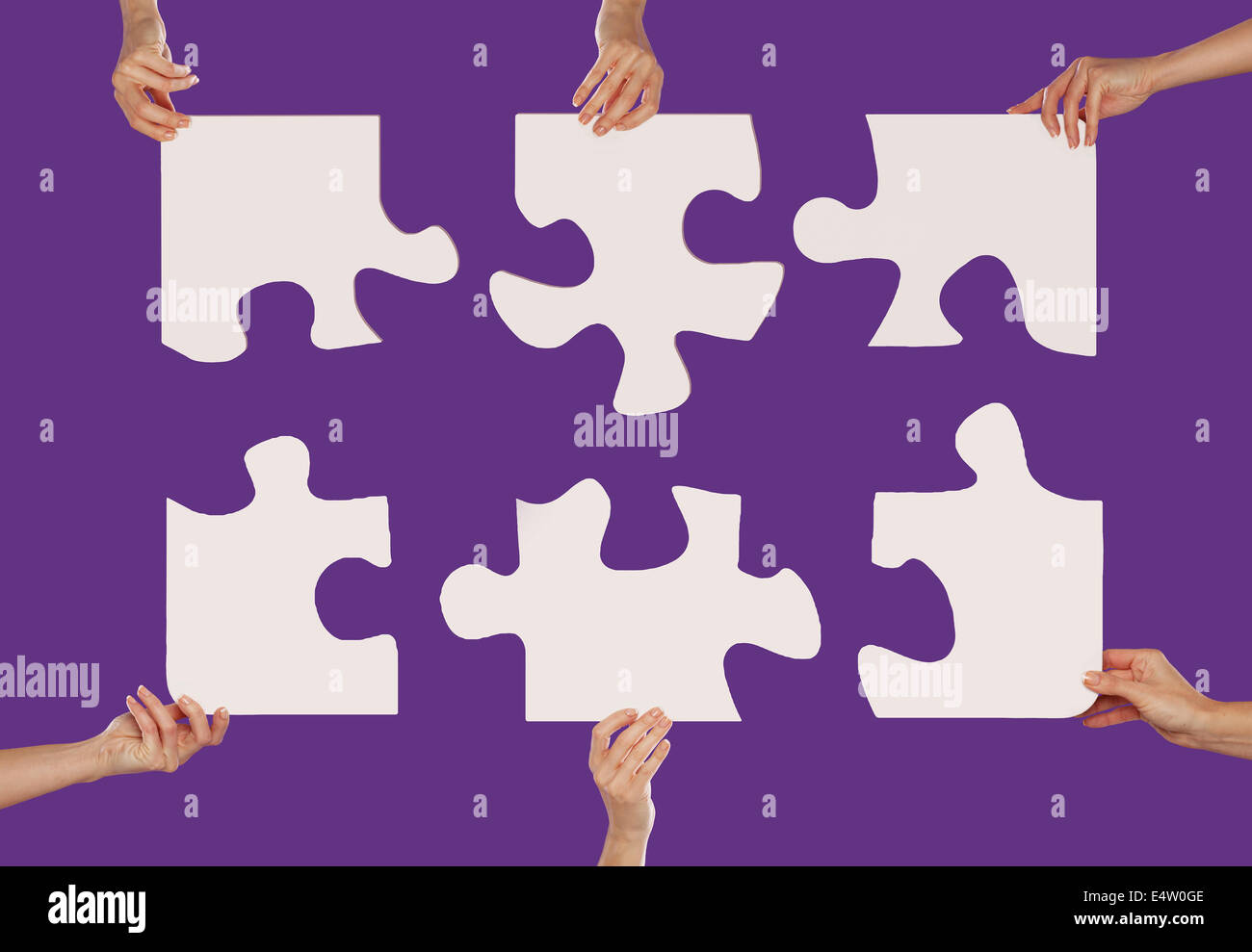 Hands and puzzle Stock Photo - Alamy