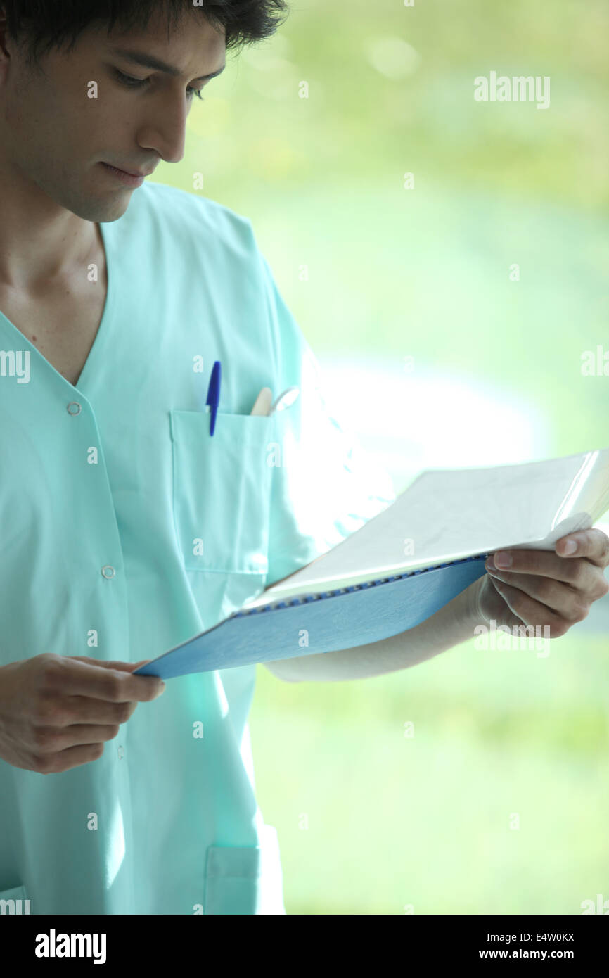 Nurse reading notes Stock Photo - Alamy