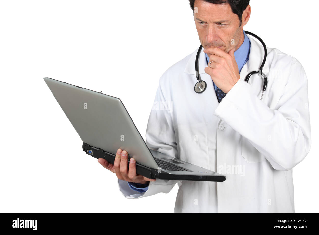 Doctor looking at laptop Stock Photo - Alamy