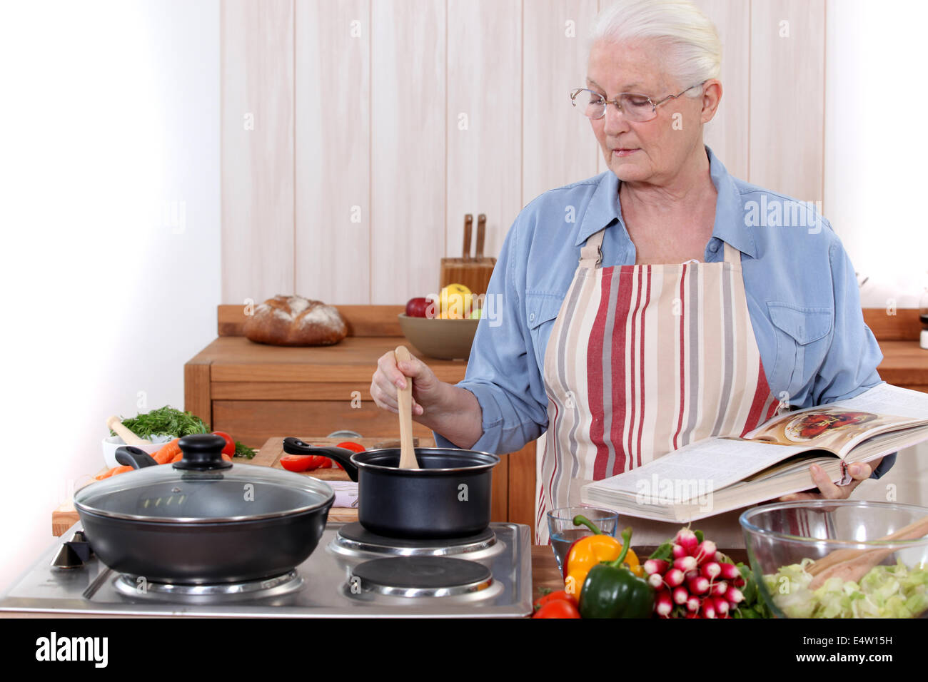 Old woman cooking Stock Photo - Alamy