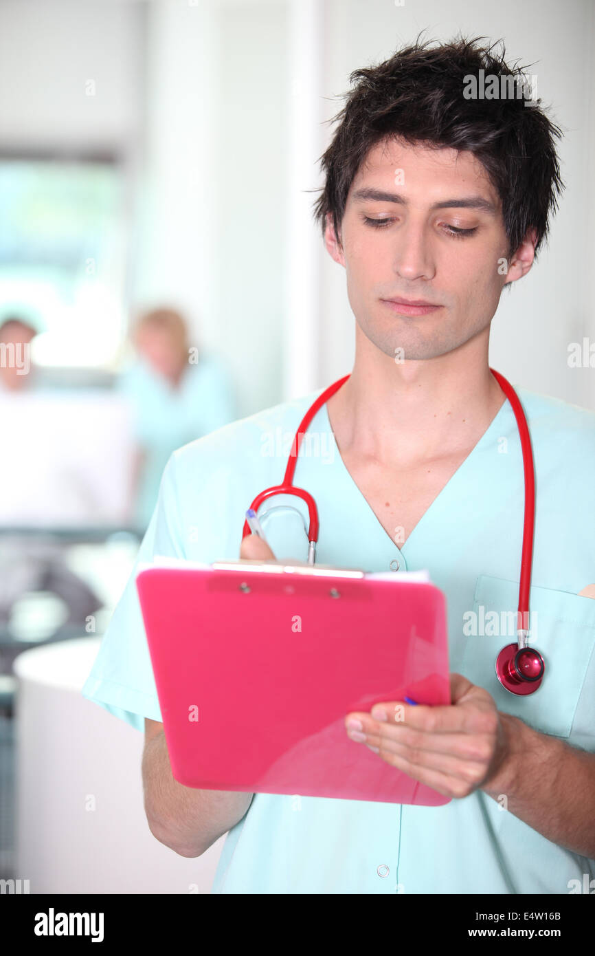 Nurse checking notes Stock Photo - Alamy