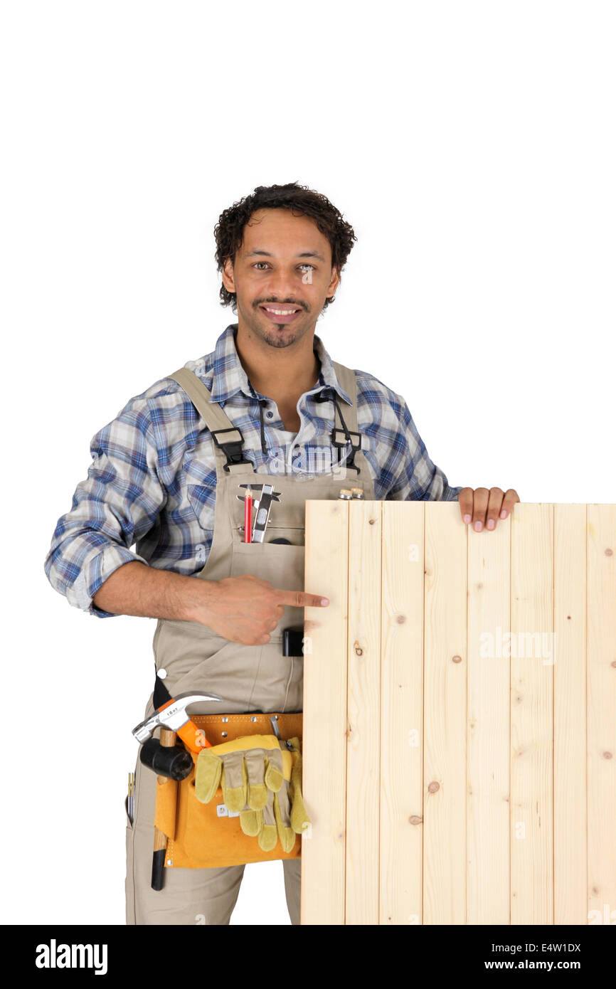 Carpenter pointing to wooden panel Stock Photo - Alamy