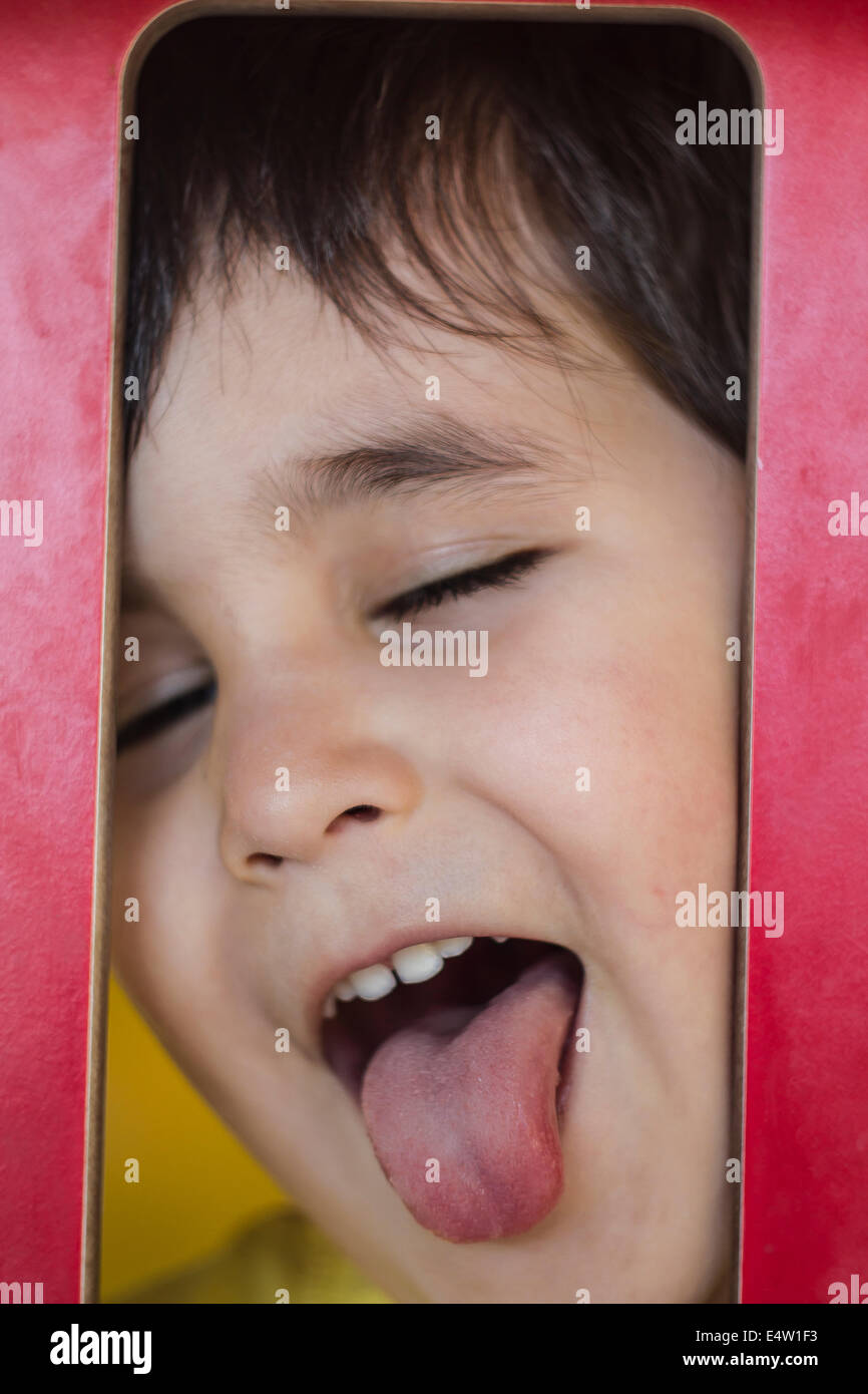 Smile, child in a park putting expressive faces Stock Photo - Alamy