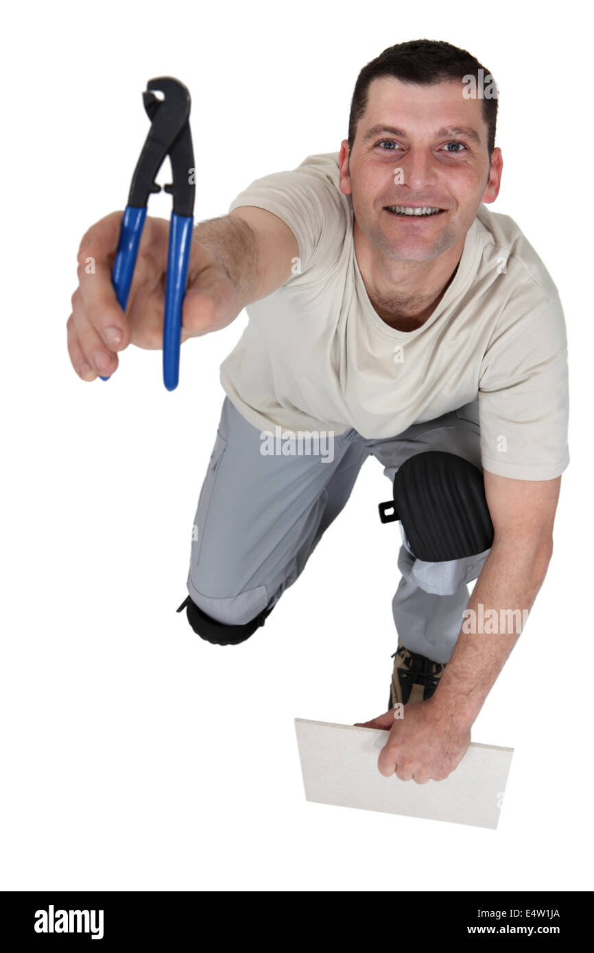 Man preparing to cut tile Stock Photo - Alamy