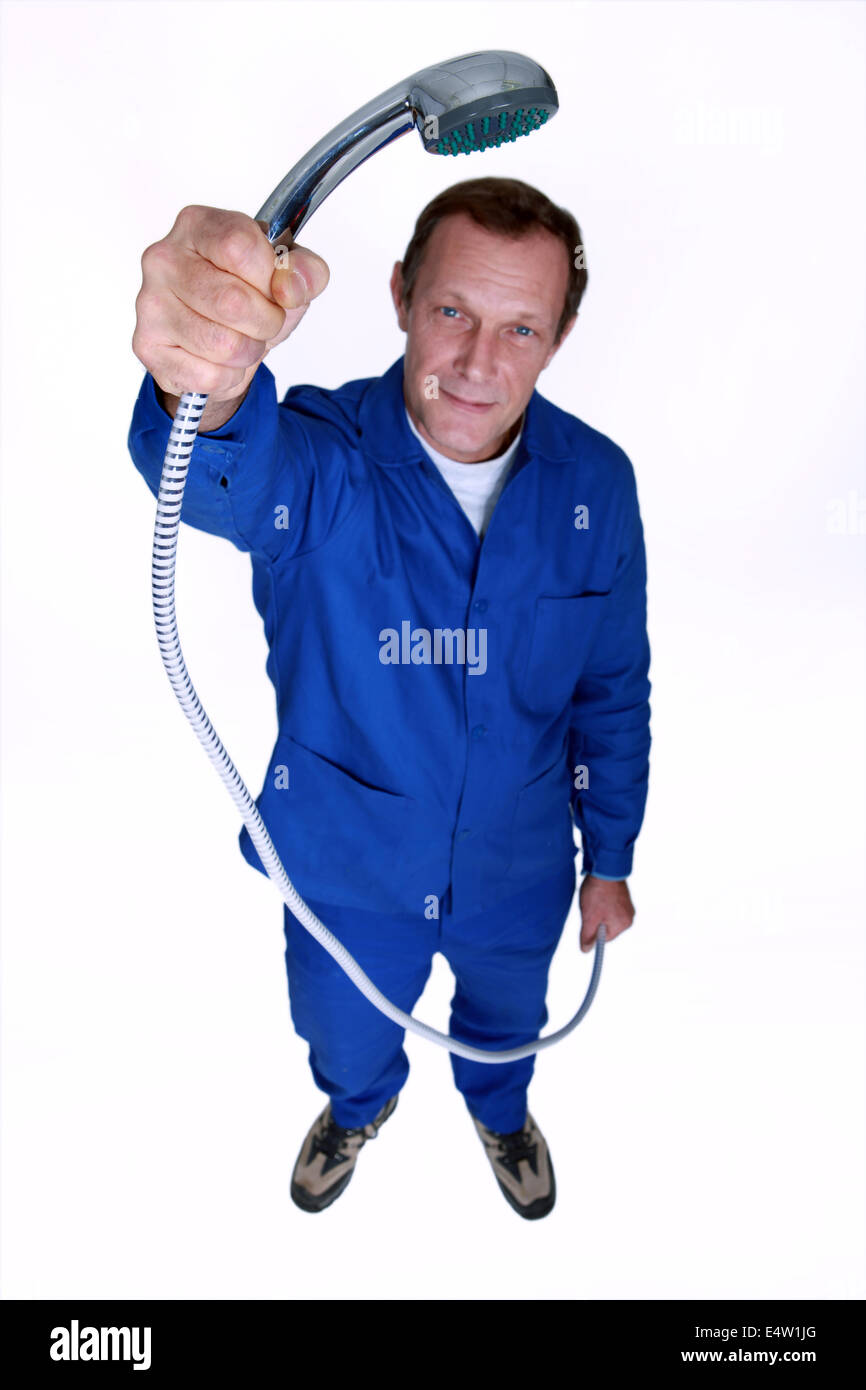 Plumber holding shower head Stock Photo - Alamy