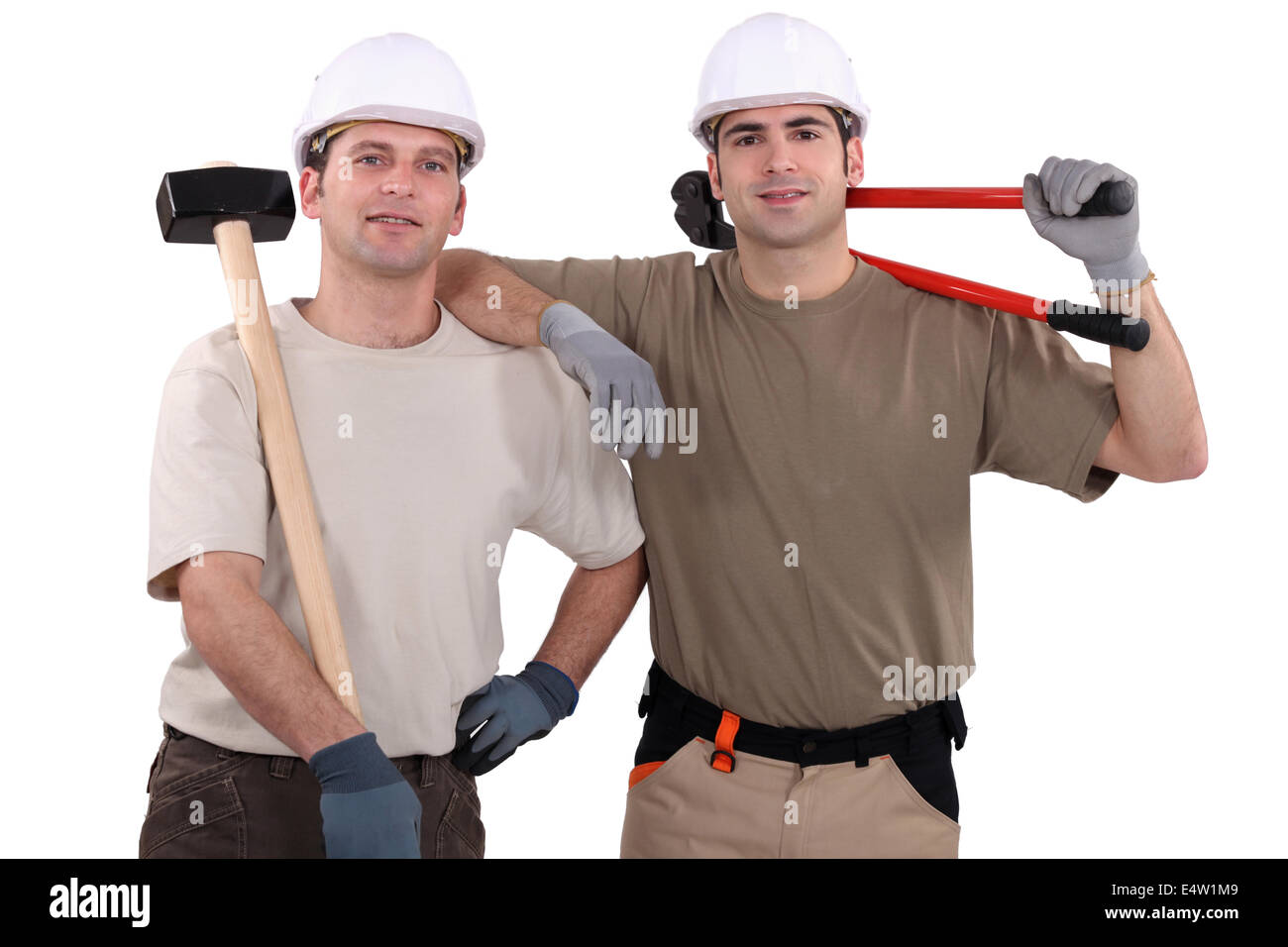 Workmen holding tools Stock Photo - Alamy