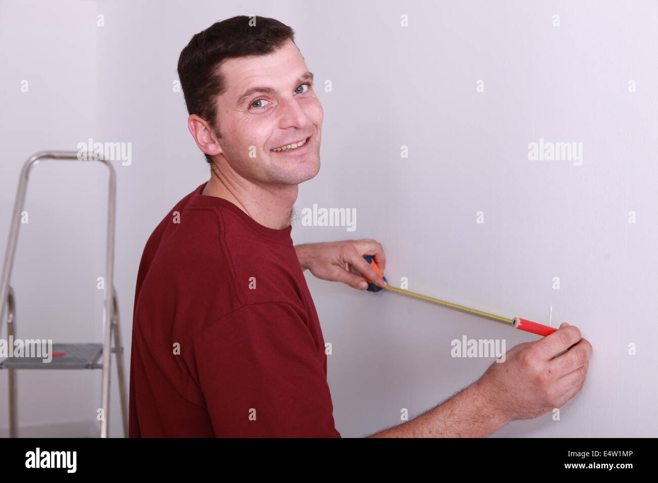 Man measuring wall Stock Photo - Alamy
