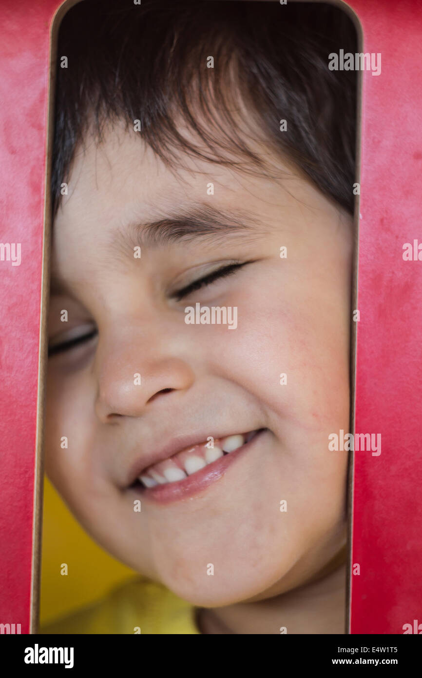 Smile, child in a park putting expressive faces Stock Photo - Alamy