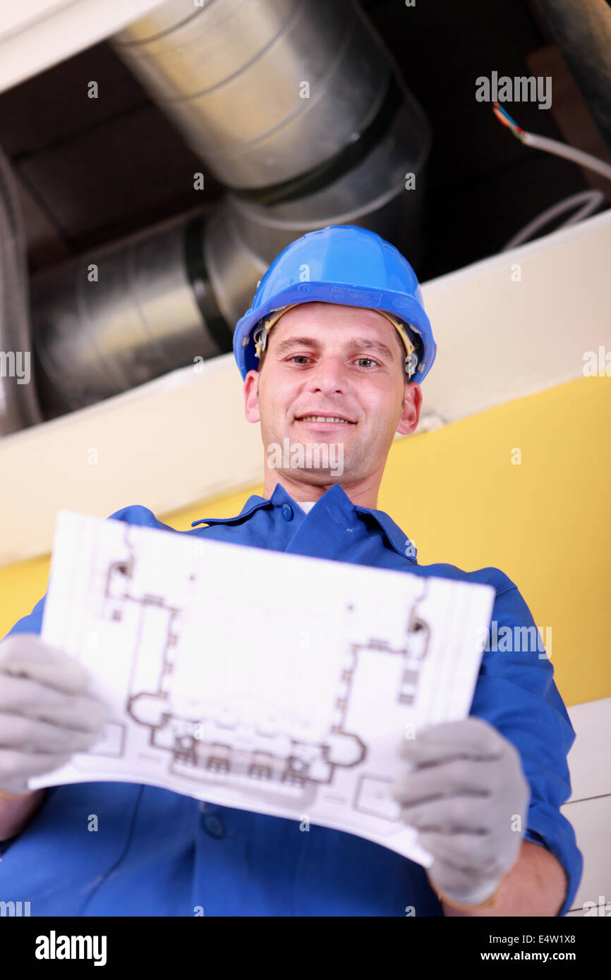 Engineer with a heating plan Stock Photo - Alamy