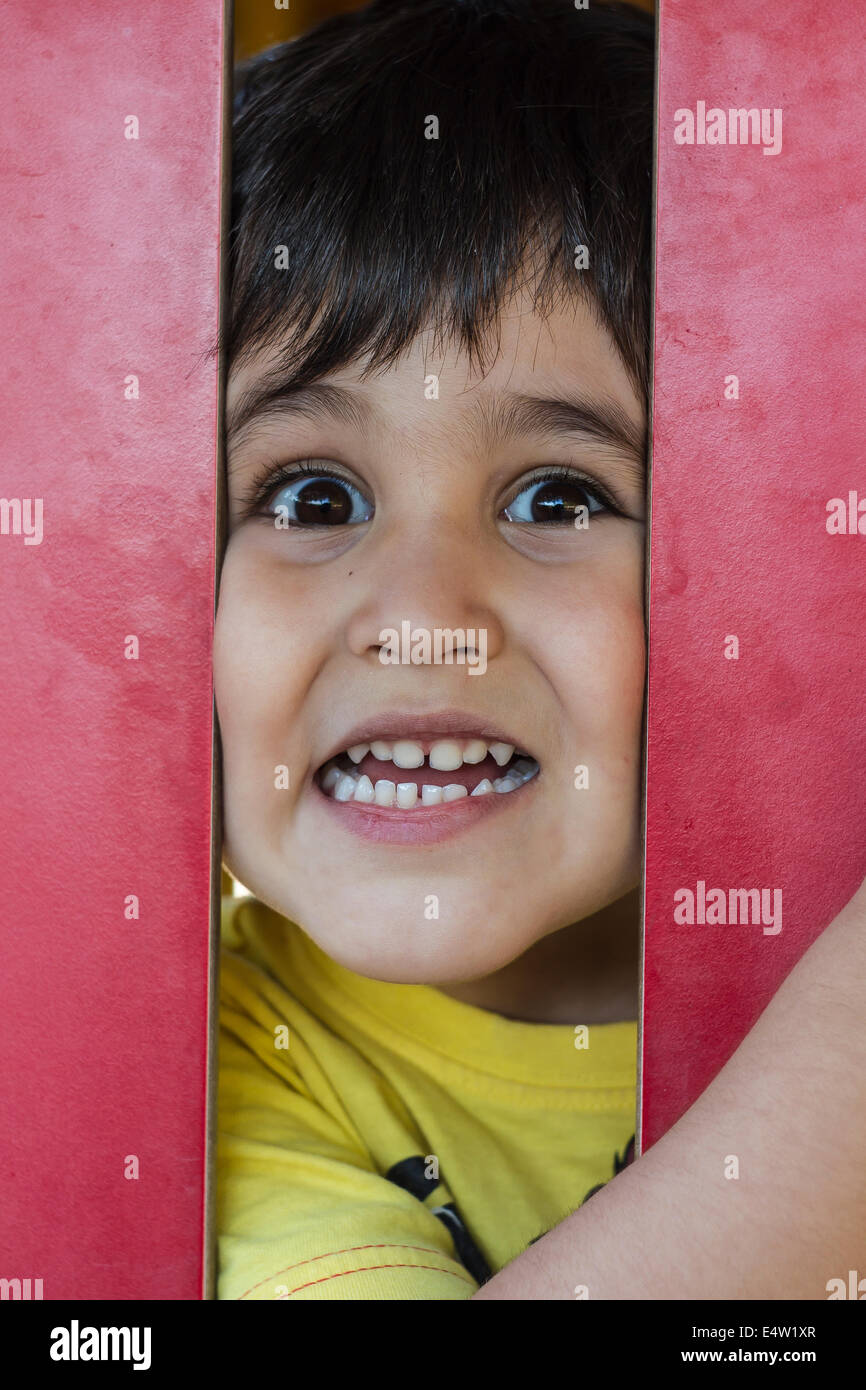 Happy child in a park putting expressive faces Stock Photo - Alamy