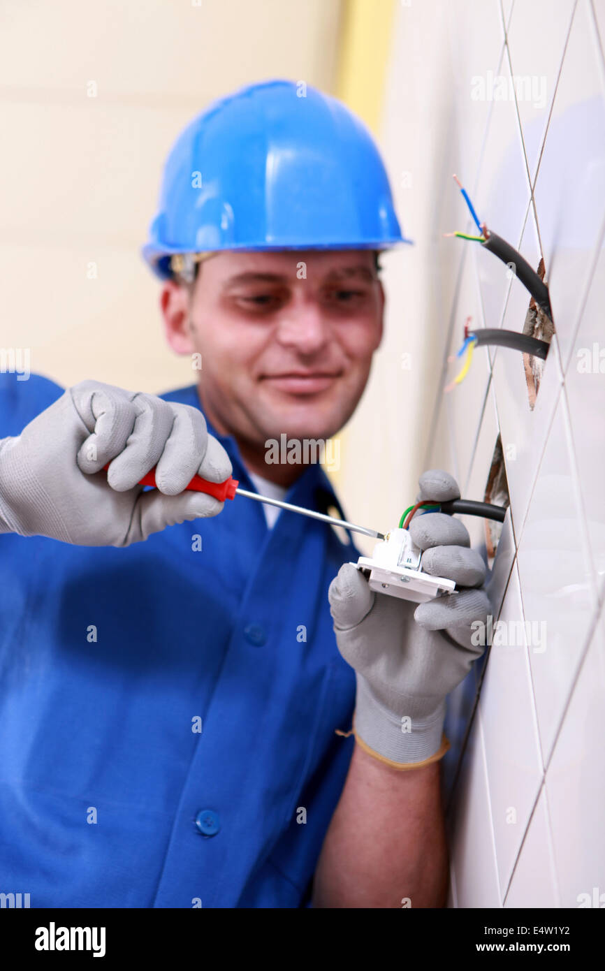 Electrician wiring a wall socket Stock Photo - Alamy