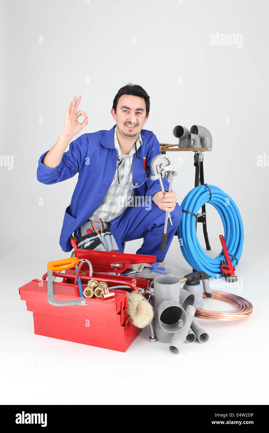 Plumber surrounded by equipment Stock Photo - Alamy