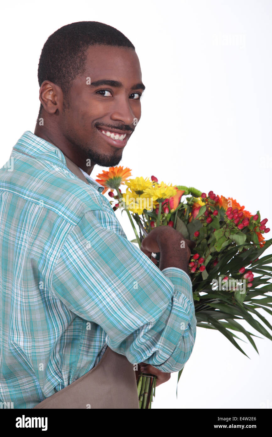 Male florist with a bunch of flowers Stock Photo - Alamy