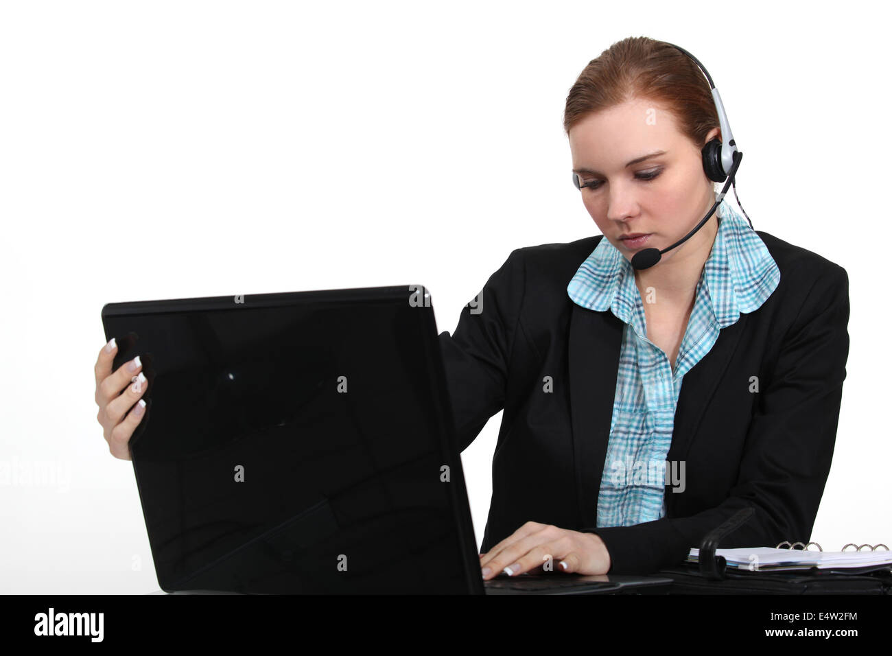 pretty receptionist with laptop and headset Stock Photo - Alamy