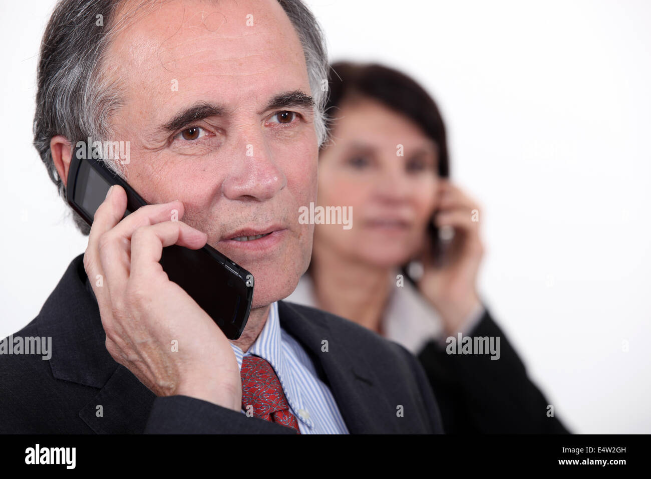 Two businesspeople making phone calls Stock Photo - Alamy