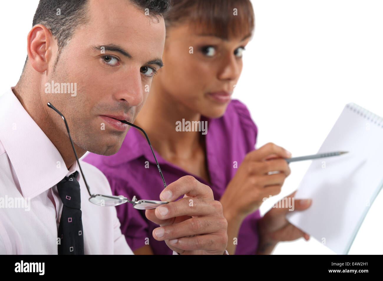 Business couple writing in a pad Stock Photo - Alamy