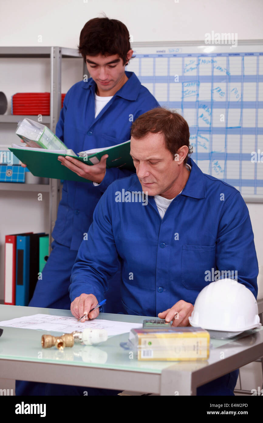 Manual workers in an office Stock Photo - Alamy