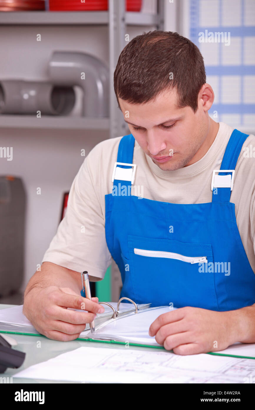 Builder looking at paperwork Stock Photo - Alamy