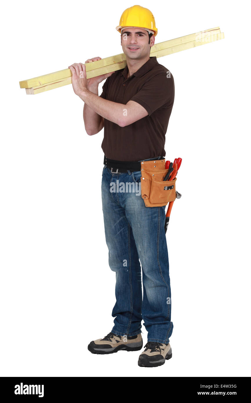 Builder carrying timber Stock Photo - Alamy