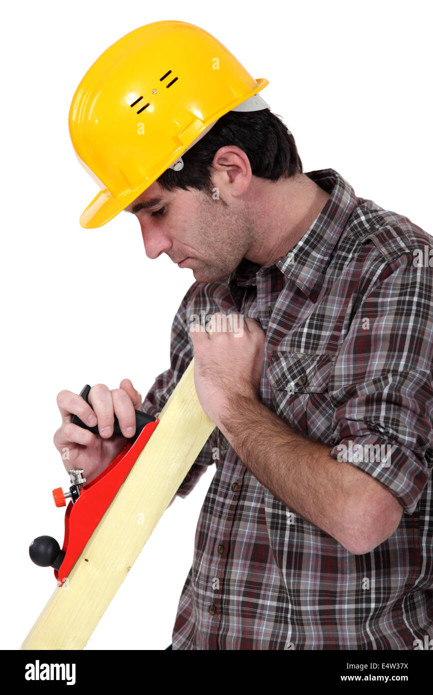 Carpenter using a wood plane Stock Photo - Alamy