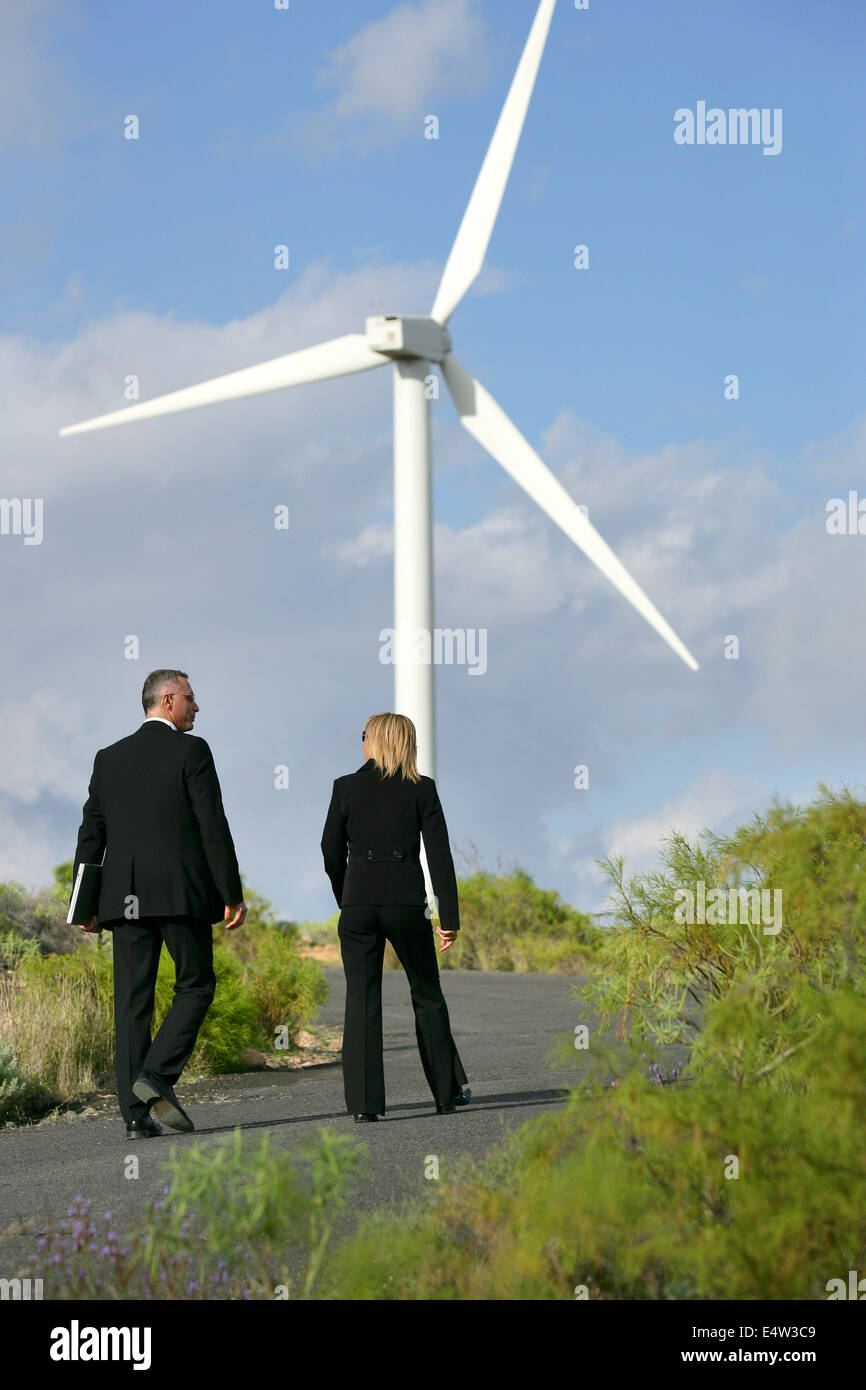 Business people by a wind turbine Stock Photo - Alamy