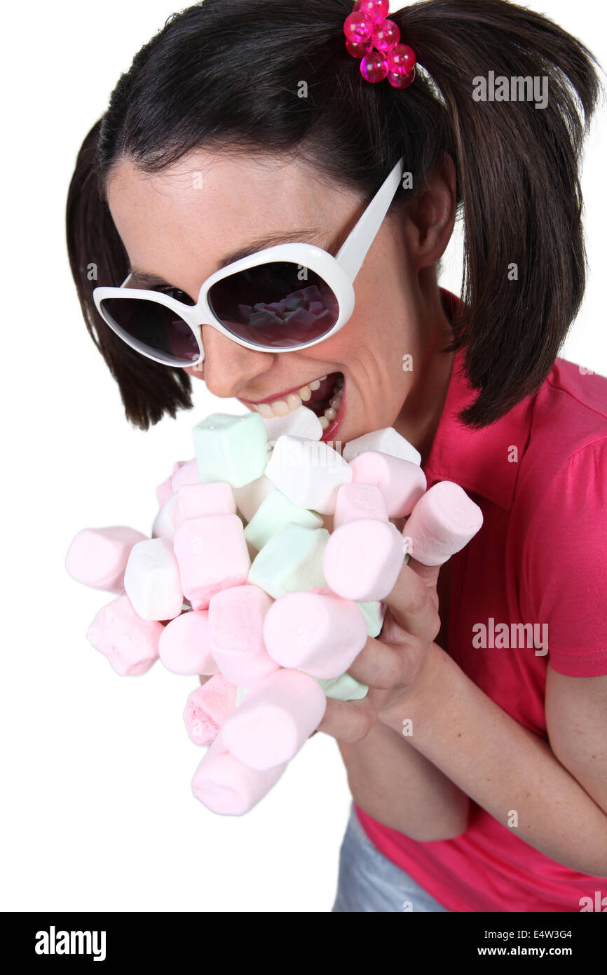 Woman scoffing marshmallows Stock Photo - Alamy