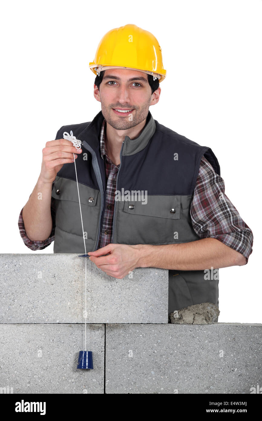 mason making measurements with a cord Stock Photo - Alamy