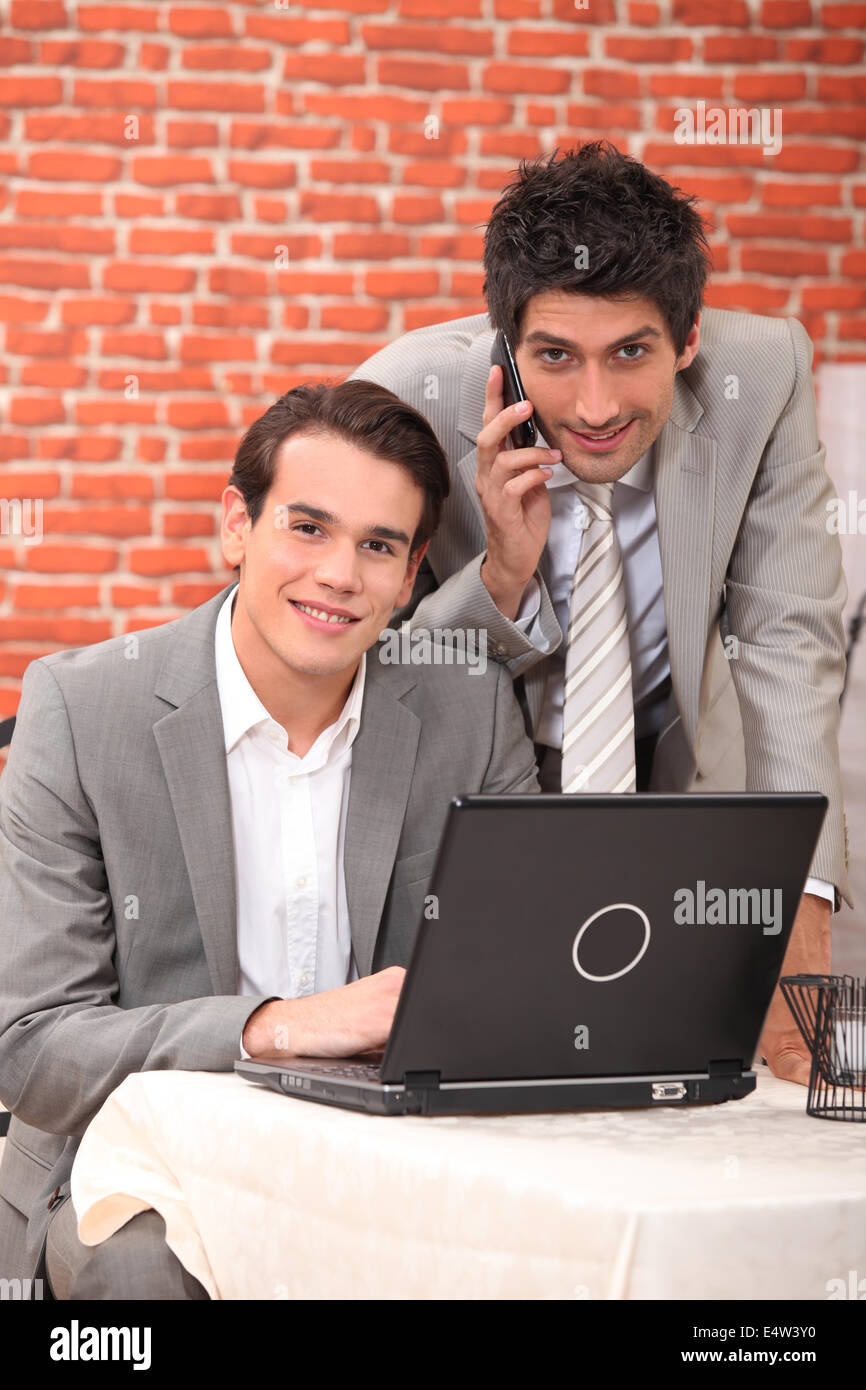 Young men using a laptop in a restaurant Stock Photo - Alamy